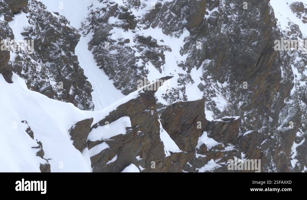 Details of a sharp, rocky area on snowy mountain walls in the Alps ...