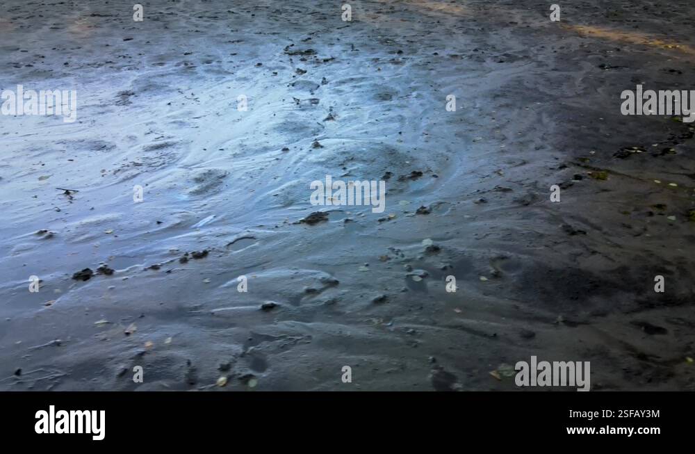 Aerial close shot of the muddy bottom of the river dried due to the ...
