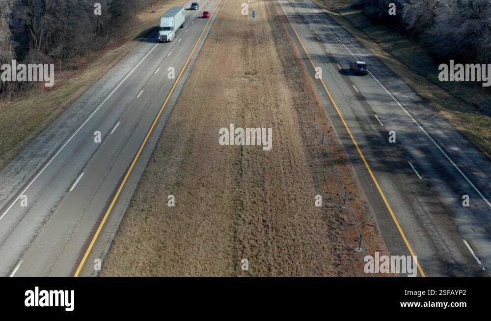 Static drone aerial view panning up to rural interstate highway road ...