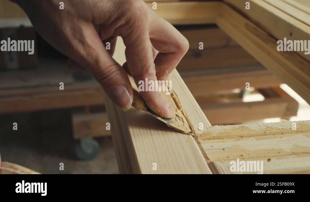 Worker Spreading Wood Putty Inside Cracks Of Window Frame At Renovation ...