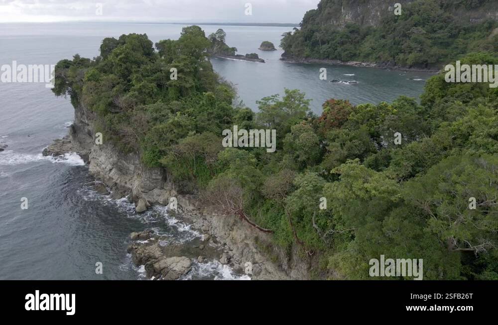 Tropical and secluded shoreline of Playa La Vaca Beach near Quepos on ...