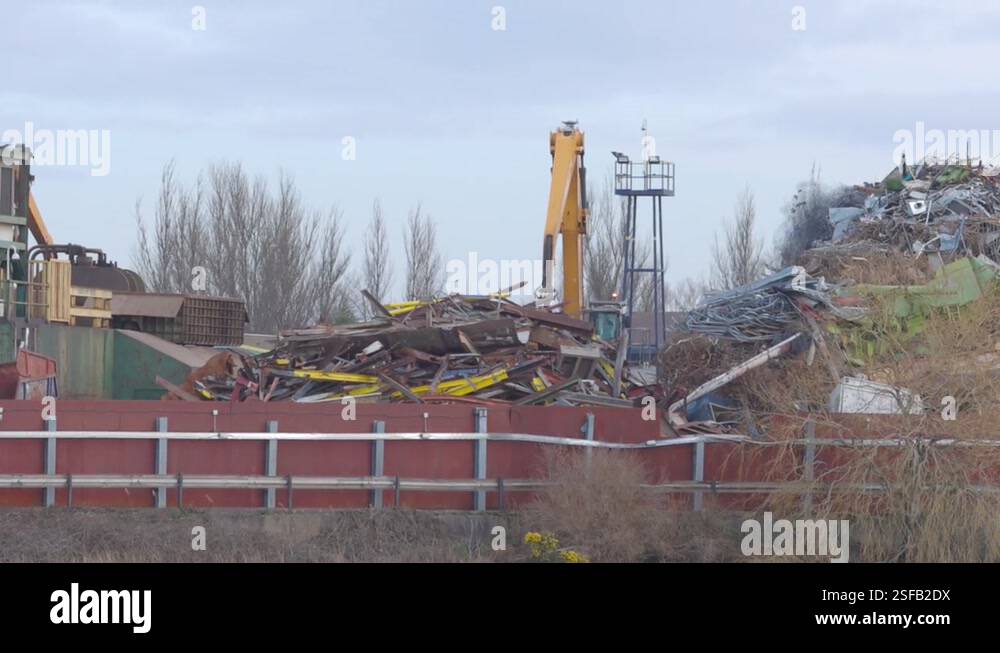 Scrapyard. Machinery processing piles of scrap metal Stock Video ...