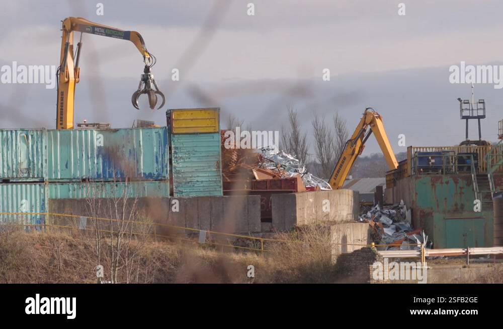 Scrapyard. Machinery processing piles of scrap metal Stock Video ...