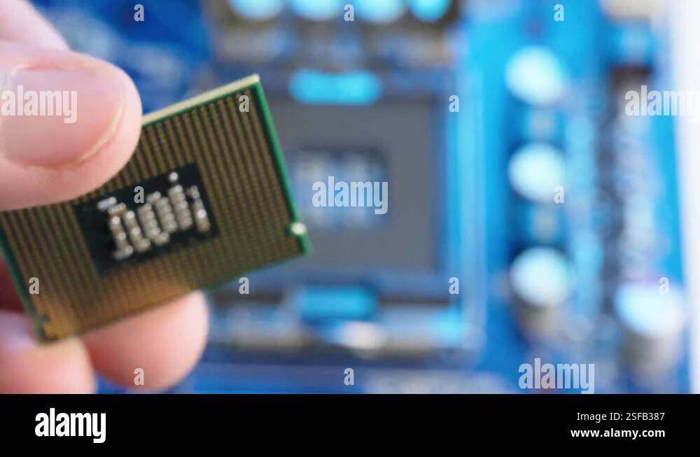 Hand holding microchip CPU Processor and placing in motherboard socket ...