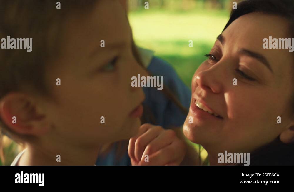 Portrair of young woman playing with son close up. Mother playful touch boy nose Stock Video ...