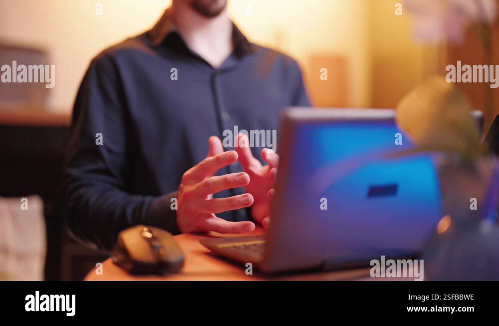 Person behind laptop computer thinking while tapping fingers together ...