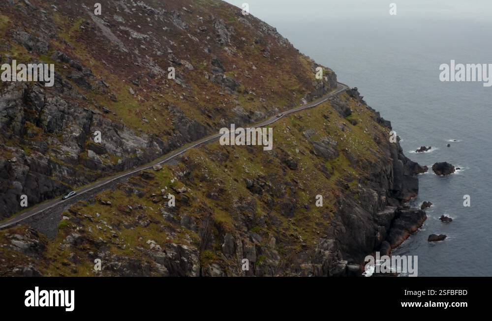Breath taking shot of slowly moving car on narrow panoramic route in ...