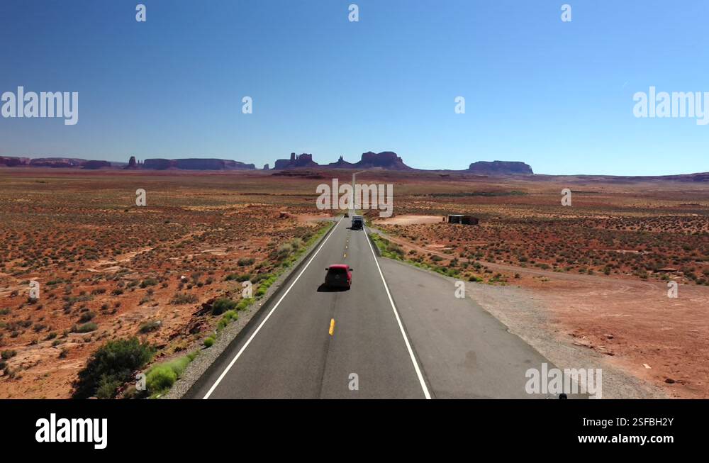 Vehicles Driving In The Road With Red Rock State Park In The Background ...