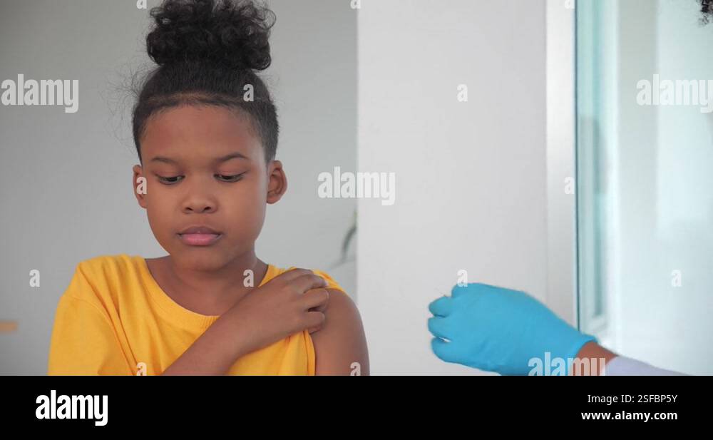 African-American kids getting vaccine in clinic or hospital, with hand ...