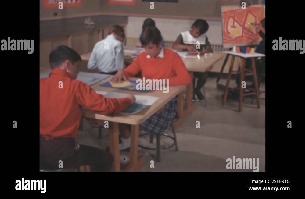 1960s: Classroom of students working on art projects: boy coloring with ...