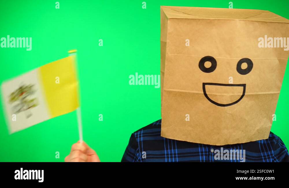Portrait of man with paper bag on head waving Vatican flag with smiling ...