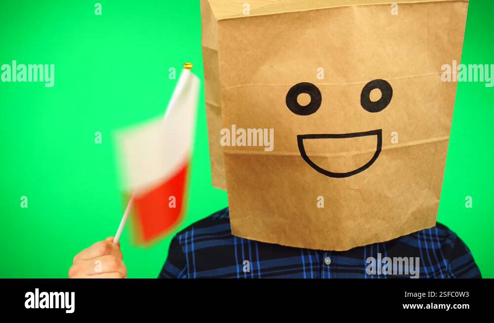 Portrait of man with paper bag on head waving Polish flag with smiling ...