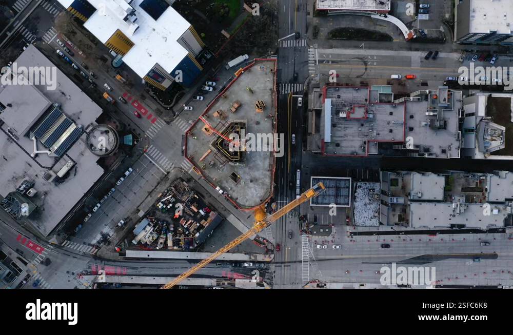 Overhead time lapse of cranes building a skyscraper in downtown Seattle ...