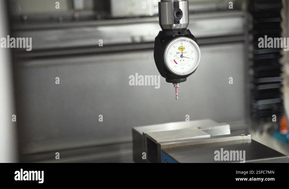 3D Taster dial indicator on a CNC machine lowered onto a steel bar ...