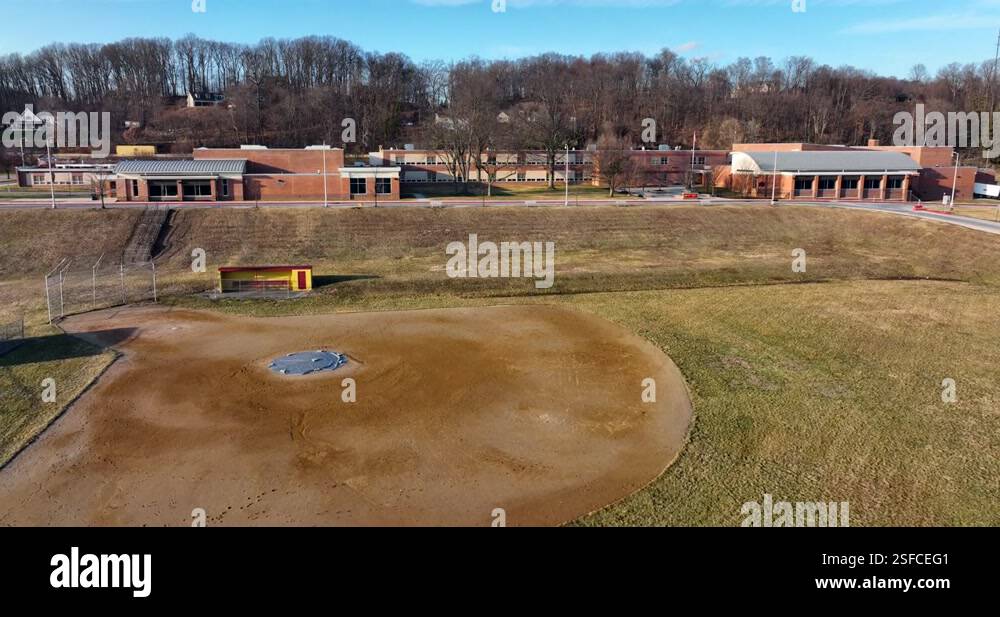 Baseball field at American school. Rising aerial reveals grass field ...