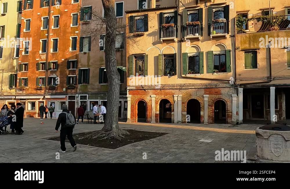 People walk in main square of Venetian Ghetto or Campo del Ghetto Nuovo ...