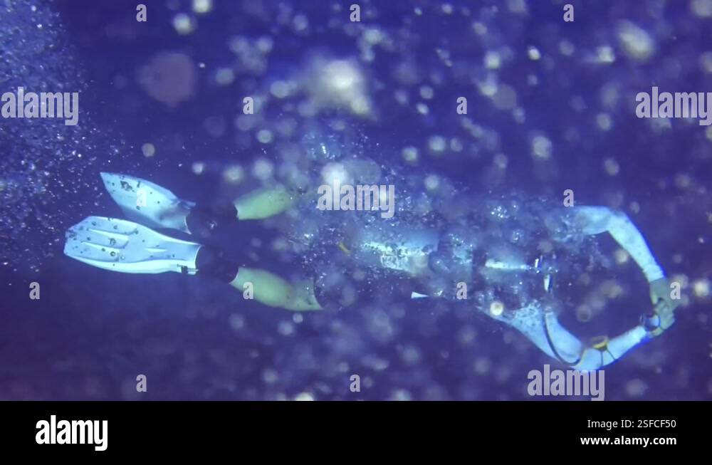 Underwater top view of diver who swim in sea full of oxygen bubbles ...