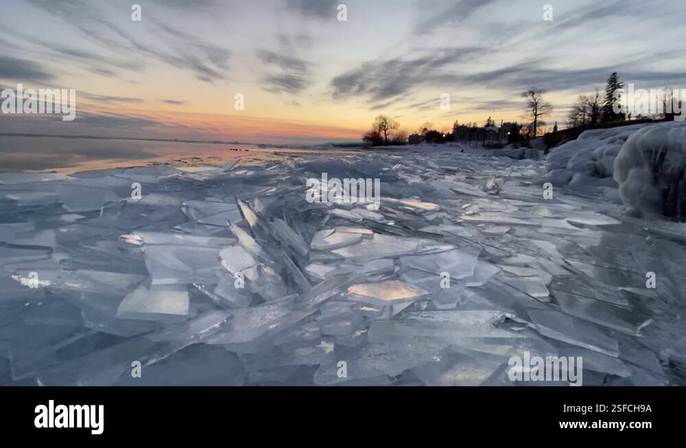 Beautiful winter sunset with incredible ice formations stacked on Lake ...