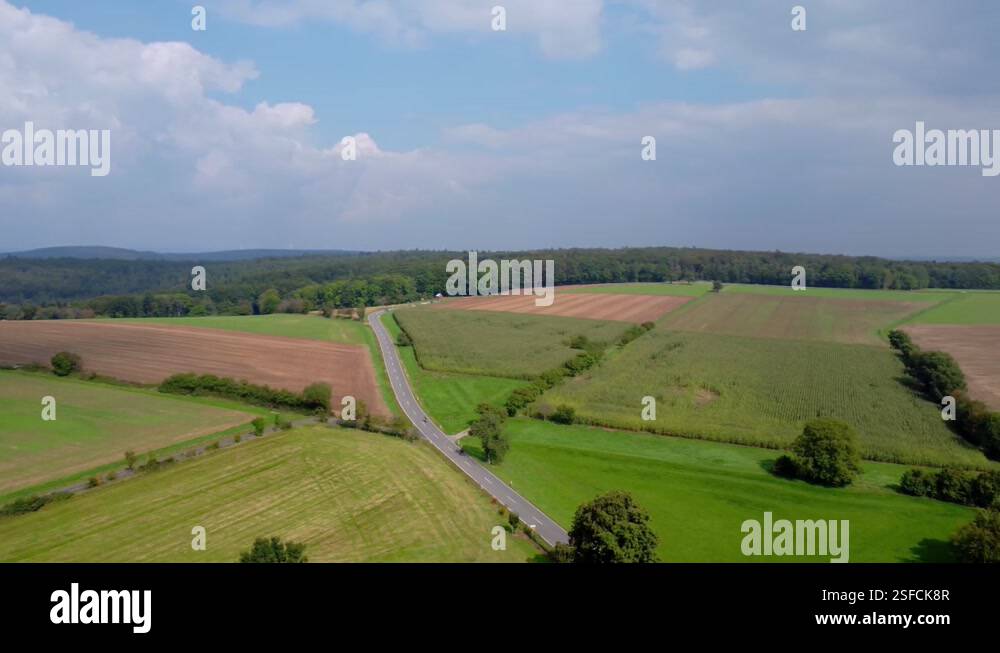 road on a hill next to the fields Stock Video Footage - Alamy
