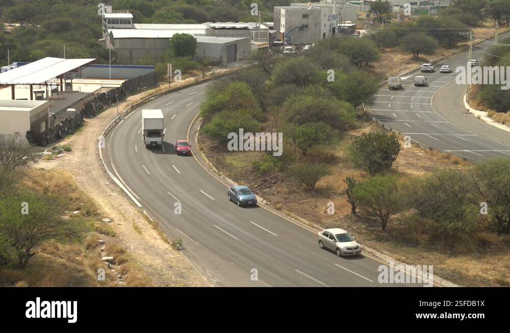 A time lapse of a highway with cars in a growing city in México ...