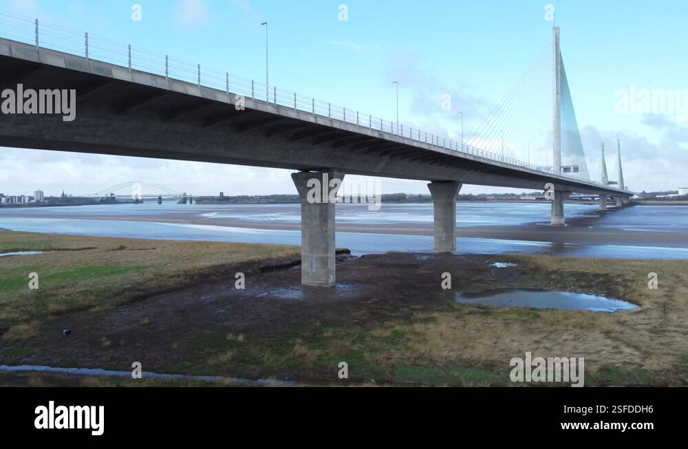 Mersey gateway landmark toll bridge at low tide with river marshland ...