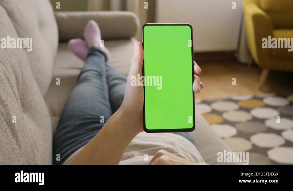 Chroma Key Mock-up Screen on Smartphone in Hand. Woman Lying on Couch with Gr Stock Video ...