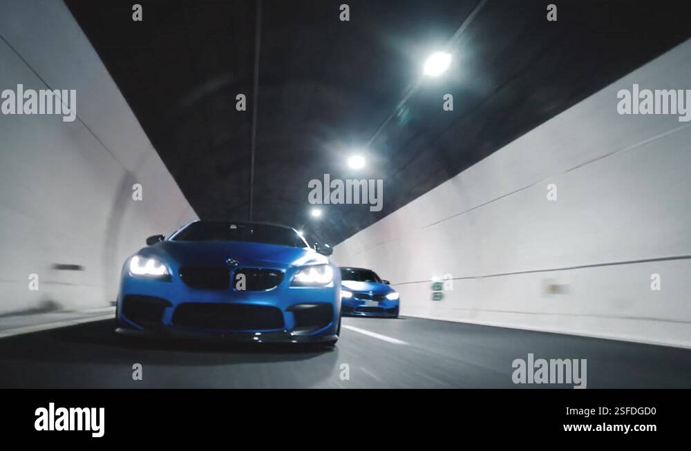 Rolling shots of two cars BMW M3 and BMW M6 racing at high speed in a ...