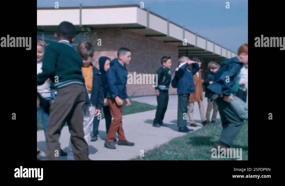 1950s: Children cheering on a wheelbarrow race. Teams of children ...