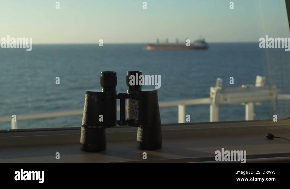 Binoculars. Window of ship's bridge. Vessel in background. Ship sailes Stock Video Footage - Alamy