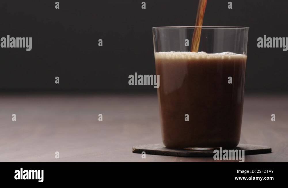 Slow motion pour stout beer in tumbler glass Stock Video Footage - Alamy