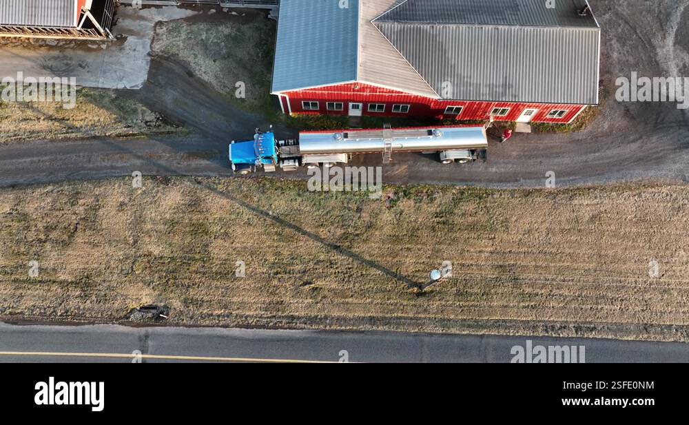 Milk truck tanker trailer for hauling milk from dairy farm. Aerial tilt ...