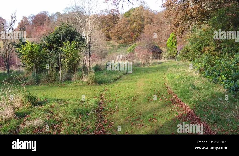 Walk through a scottish country home garden with a loch and mountain ...