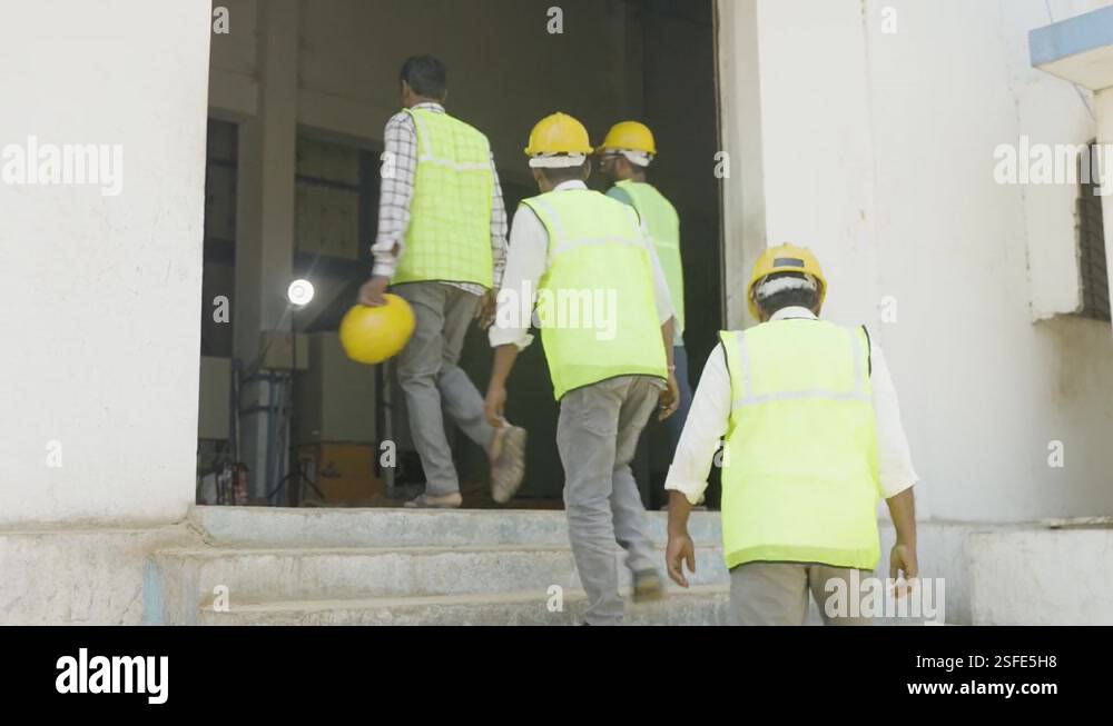 group of Industrial workers coming to work at factory - concept of ...