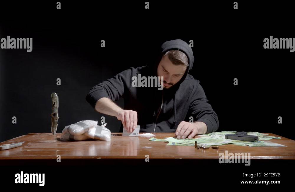 Man Forms Lines Of Cocaine Powder On The Table For Snorting. Illegal ...