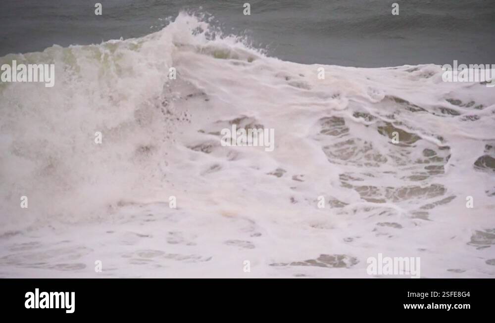 Slow motion waves with white foam in the middle of a storm in the ocean ...