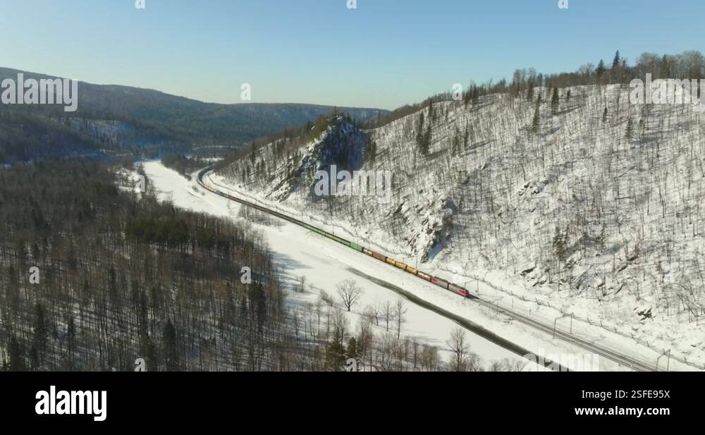 Freight long train carries with cargo carriages in hard to reach wild ...