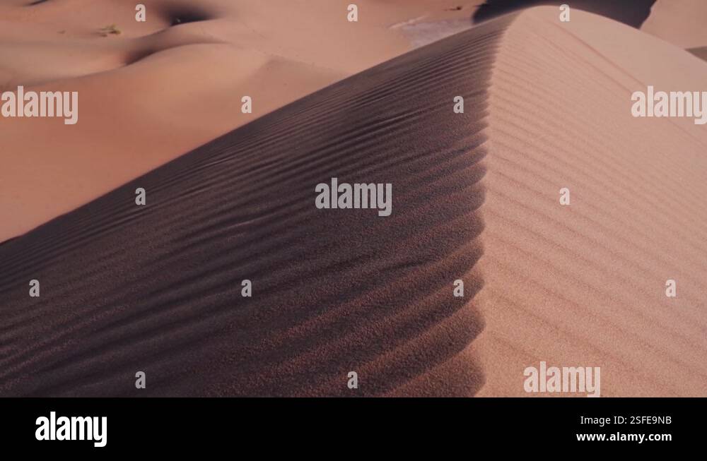Wind blowing sand on sandy dune peak of Sahara desert, handheld view ...