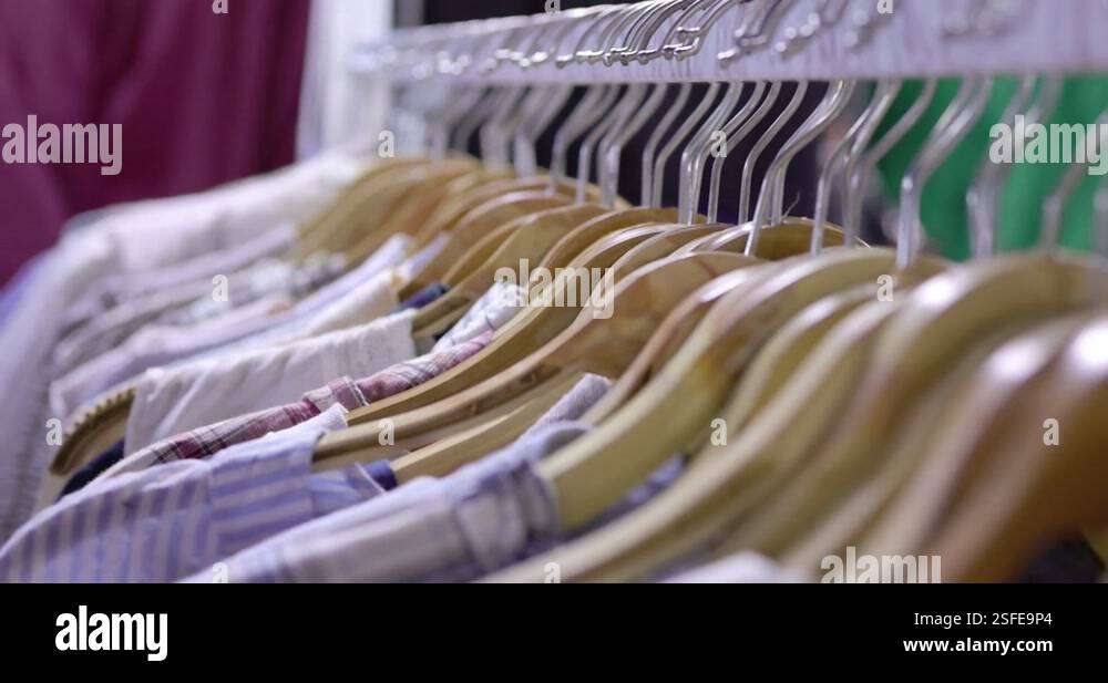 Close up cloth and dress hanging with rack in mall shop or cloth store ...