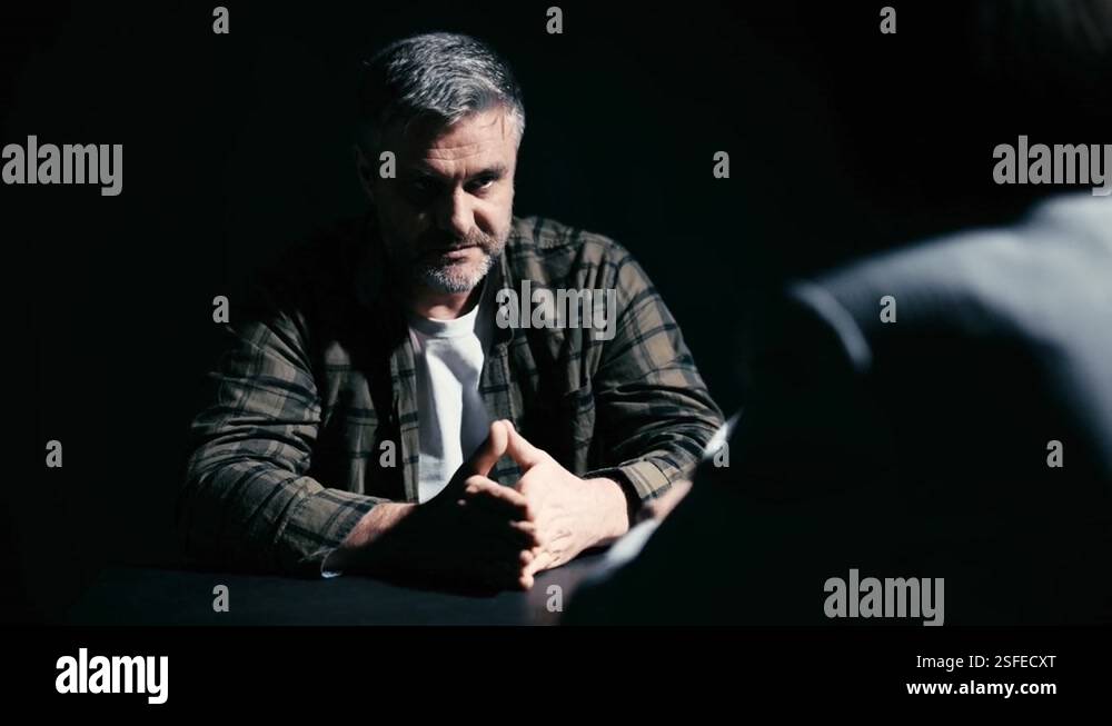 Police detective questioning detained man about evidence, investigation ...