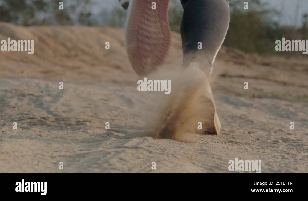 Close-up of the feet of an athlete wearing athletic shoes running on a ...