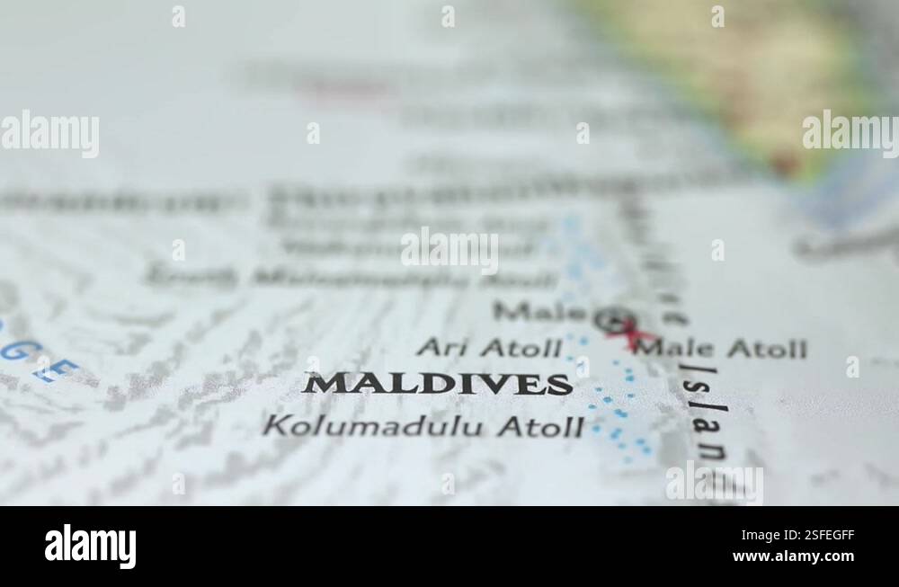 Location Maldives islands, man push pin on travel map, marker close-up ...