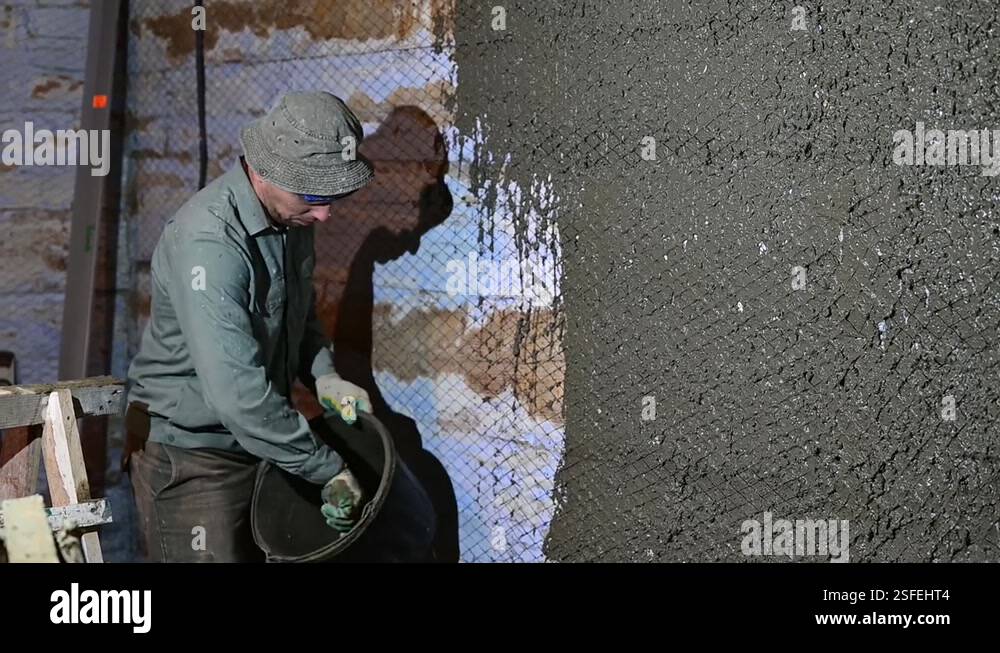 The process of plastering the wall, a man with a trowel in his hands ...
