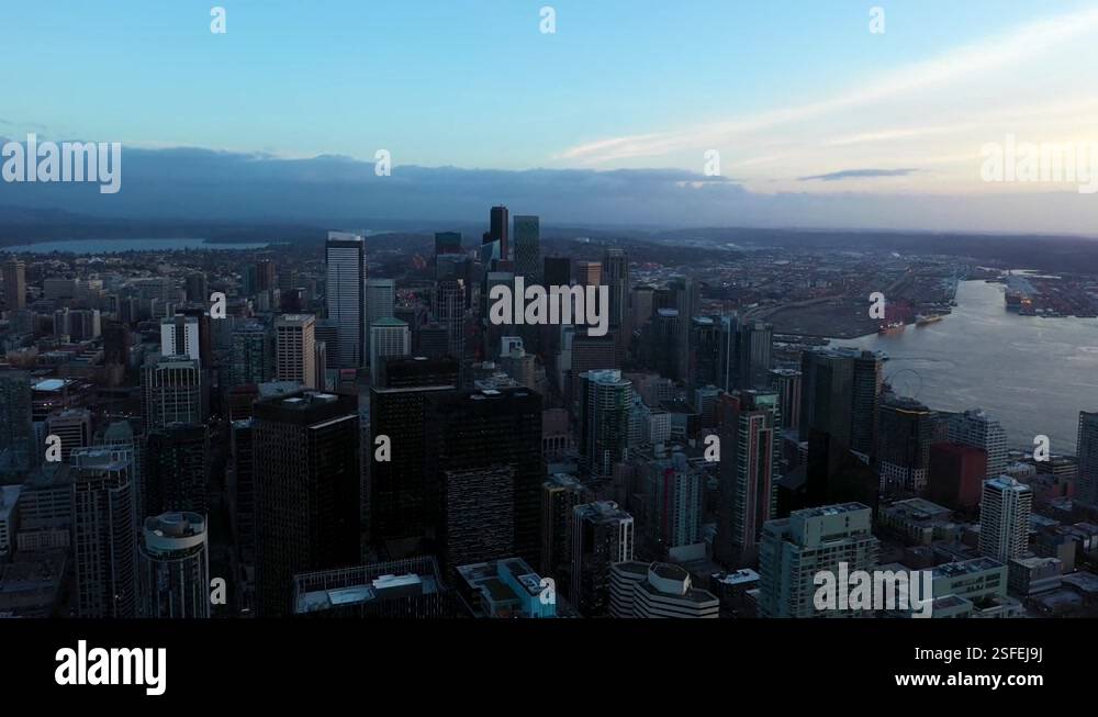 Wide establishing aerial of Seattle's downtown skyscrapers with clouds ...