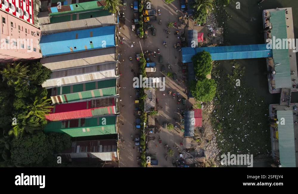 Top down aerial view of city buildings rooftop with slums and road ...