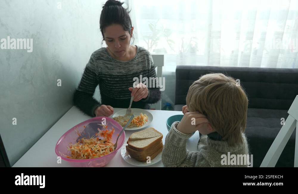 Mother with Child Eat Food at Kitchen Woman Kid Sit at Table Family ...