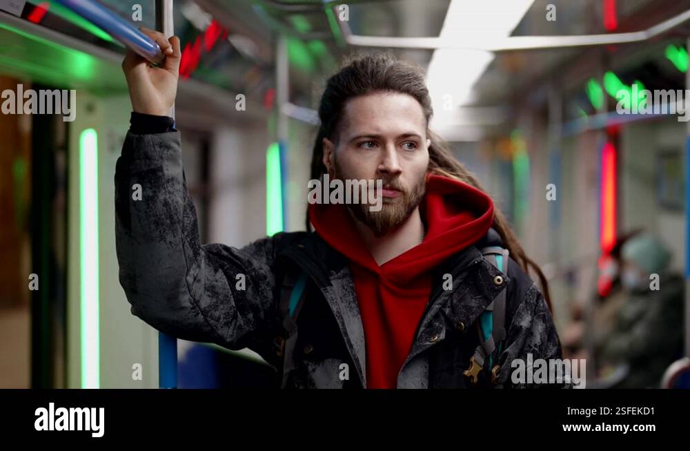 young man is riding train-car, using underground for transporting in ...