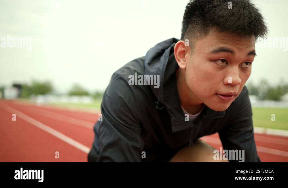 Young handsome chinese man doing star pose before running exercise on ...