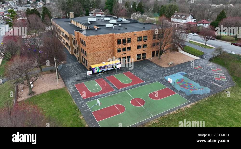School building and playground for recess. Rising pullback aerial ...