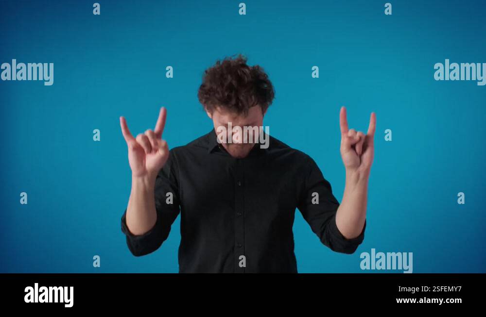 Portrait crazy male rocker screaming dancing shaking head with hands ...