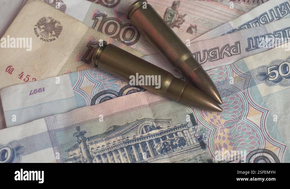 39mm machine gun bullets on Russian rubles banknotes, war and business ...